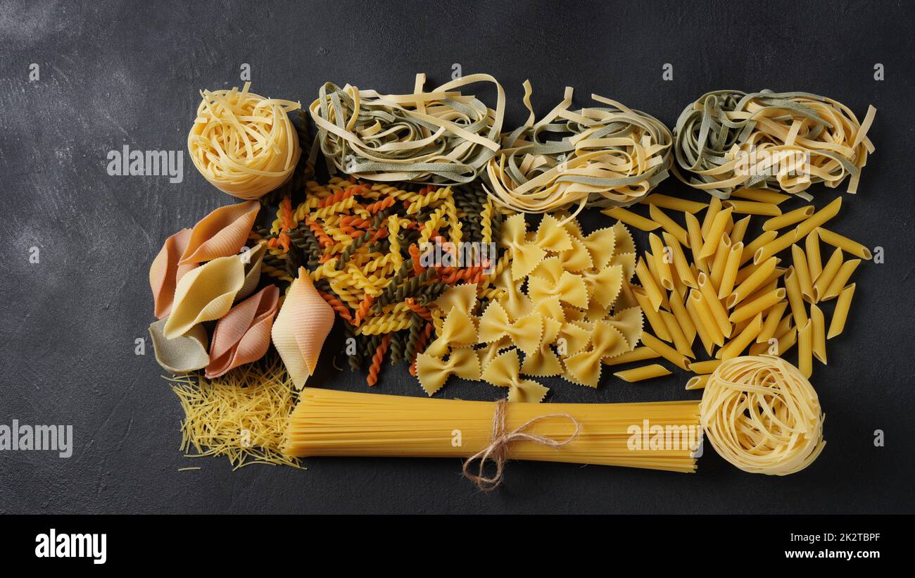 Assortment of raw pasta. Different kinds of macaroni, tagliatelle ...