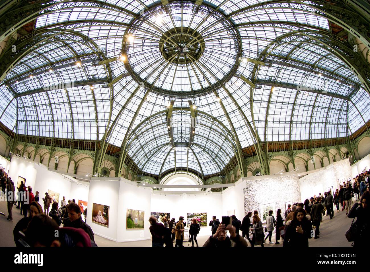The interior of the Grand Palais with glass ceiling and many tourists ...
