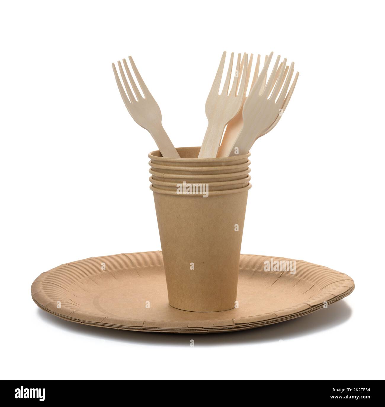 Brown paper cups, wooden fork and plates on a white background ...