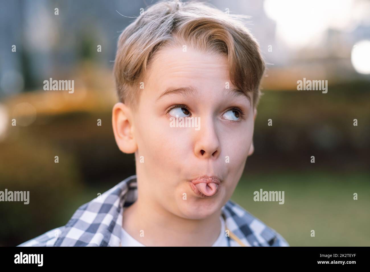 Naughty Teenager Makes Faces At The Camera Shows His Tongue And