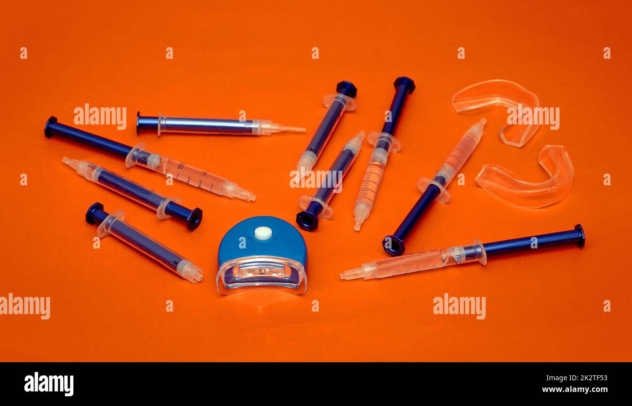 Gel syringes and led lamp for teeth whitening Stock Photo - Alamy