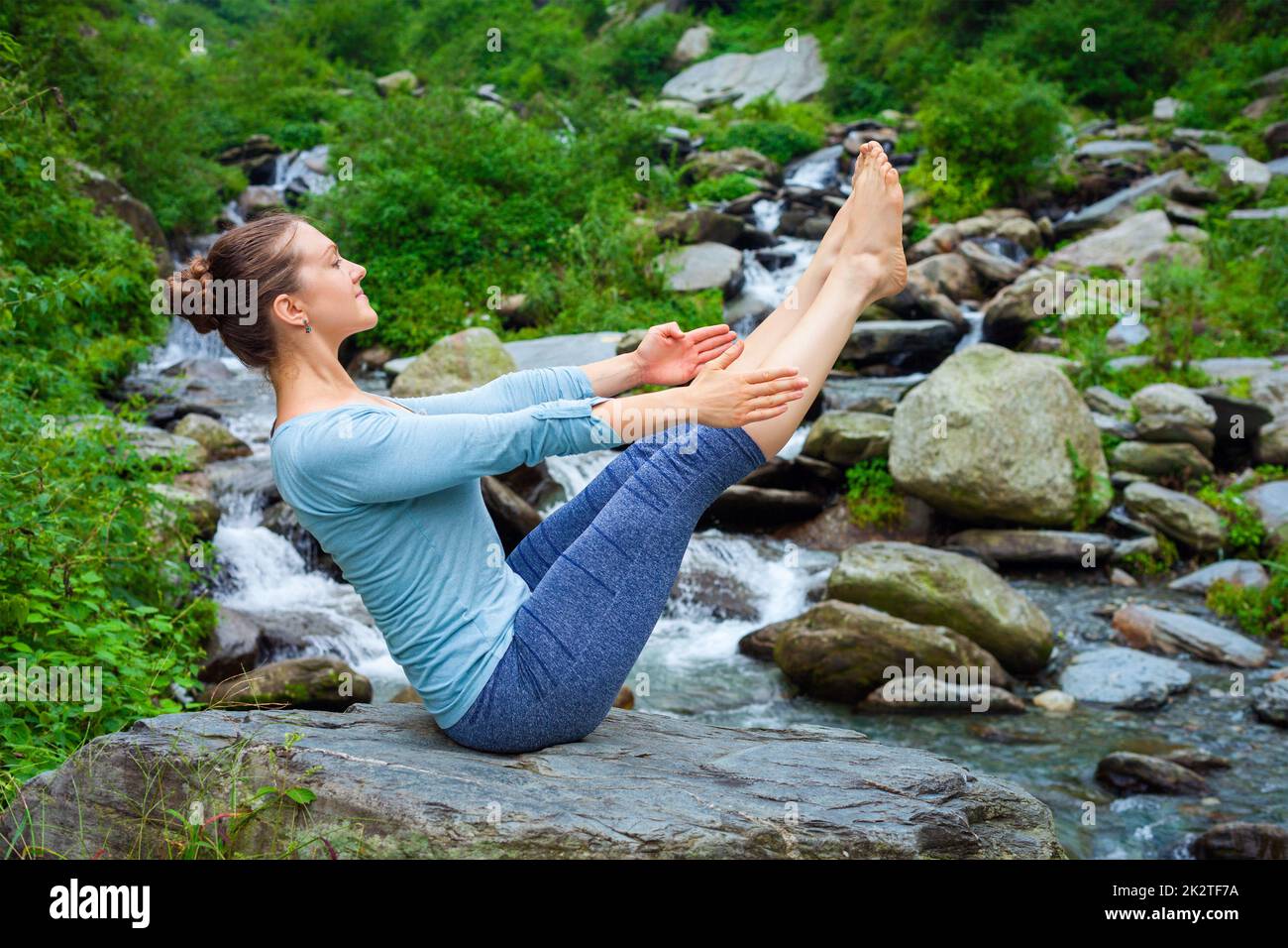 Woman doing Ashtanga Vinyasa Yoga asana Navasana outdoors Stock Photo ...