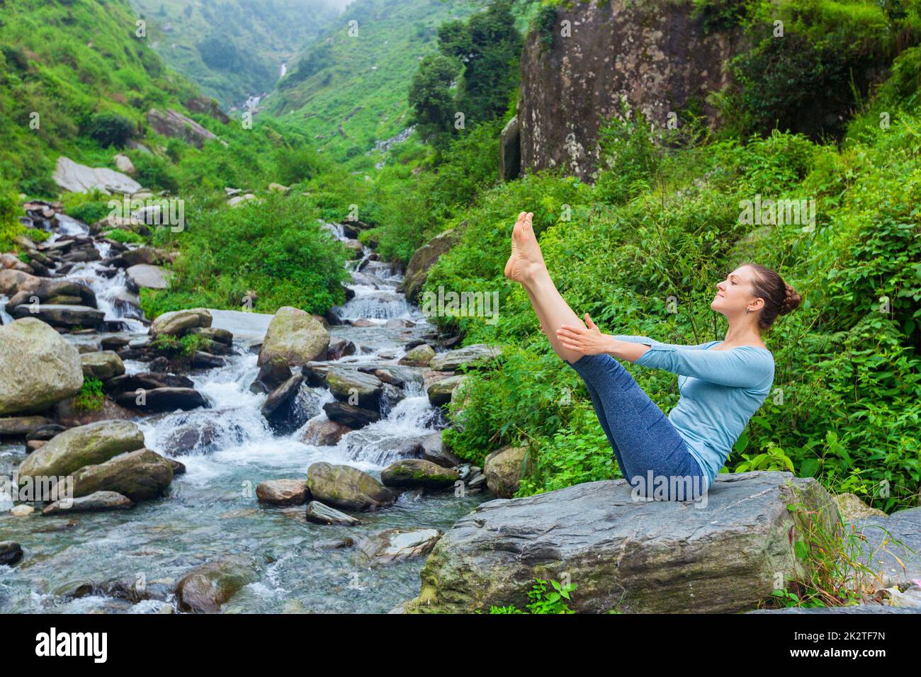 Woman doing Ashtanga Vinyasa Yoga asana Navasana outdoors Stock Photo ...