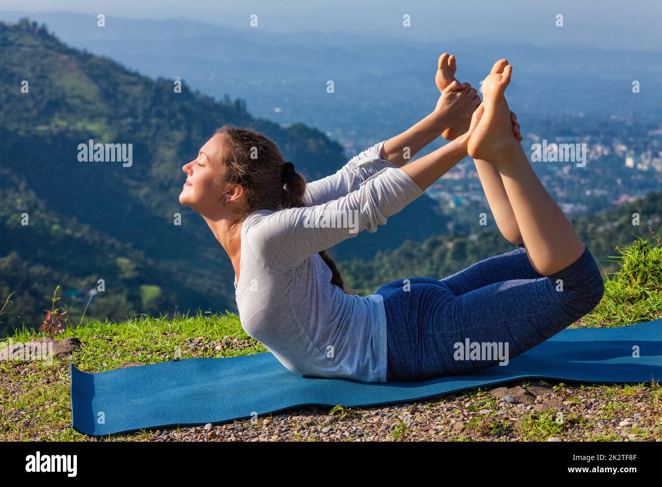 Woman doing Ashtanga Vinyasa Yoga asana Dhanurasana - bow pose Stock Photo - Alamy