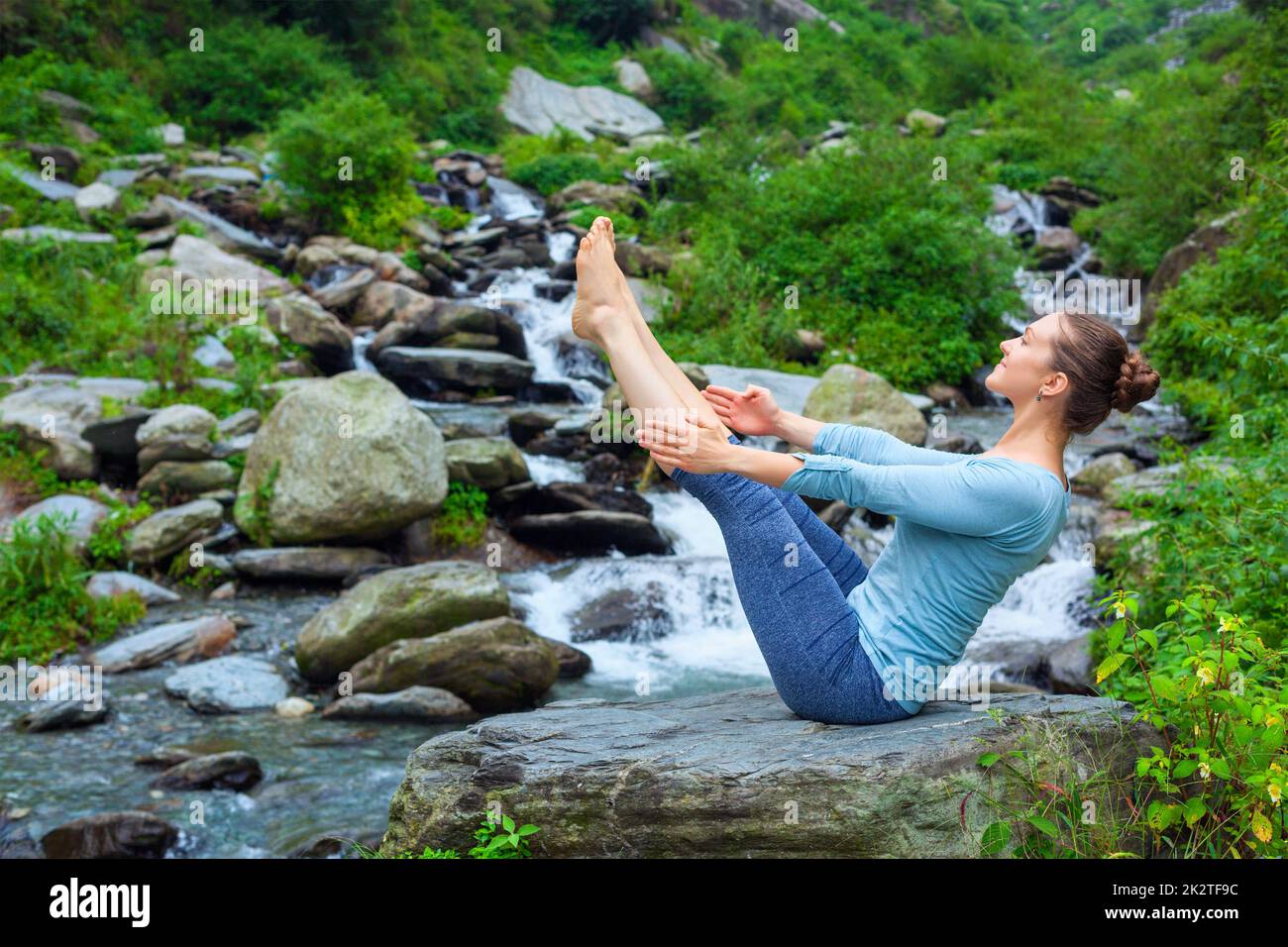 Woman doing Ashtanga Vinyasa Yoga asana Navasana outdoors Stock Photo ...
