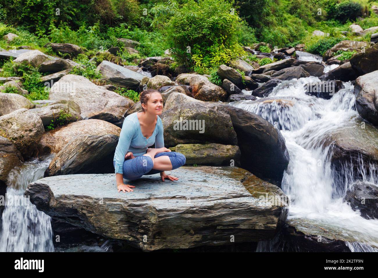 Woman doing Ashtanga Vinyasa Yoga arm balance asana Tolasana Stock ...