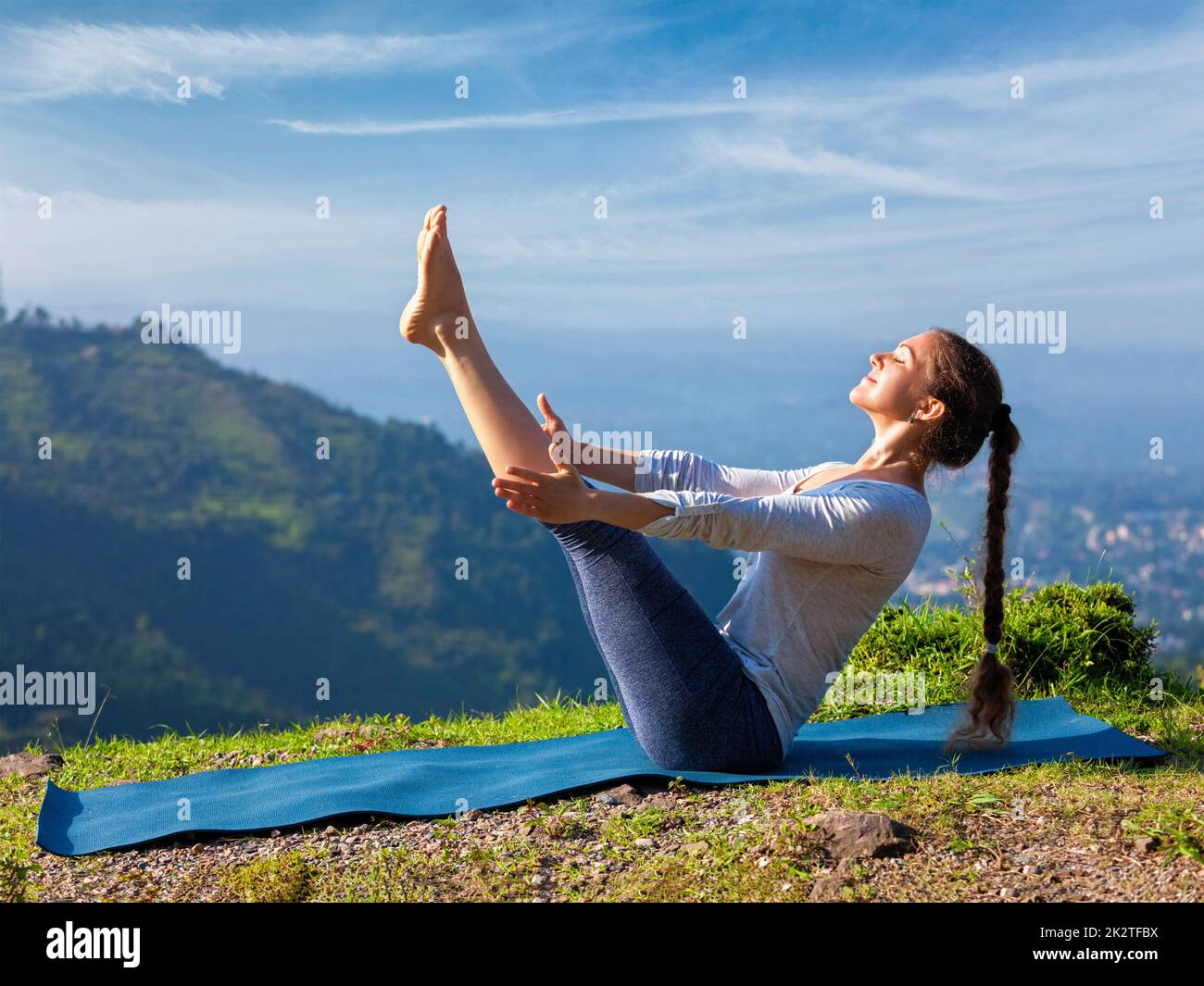 Woman doing Ashtanga Vinyasa Yoga asana Navasana - boat pose Stock ...