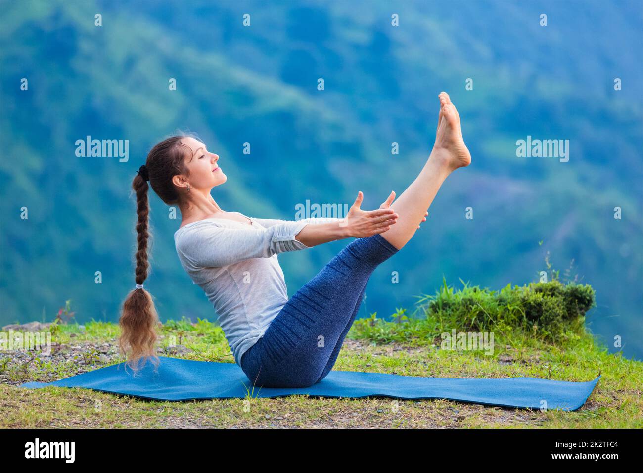 Woman doing Ashtanga Vinyasa Yoga asana Navasana - boat pose Stock ...