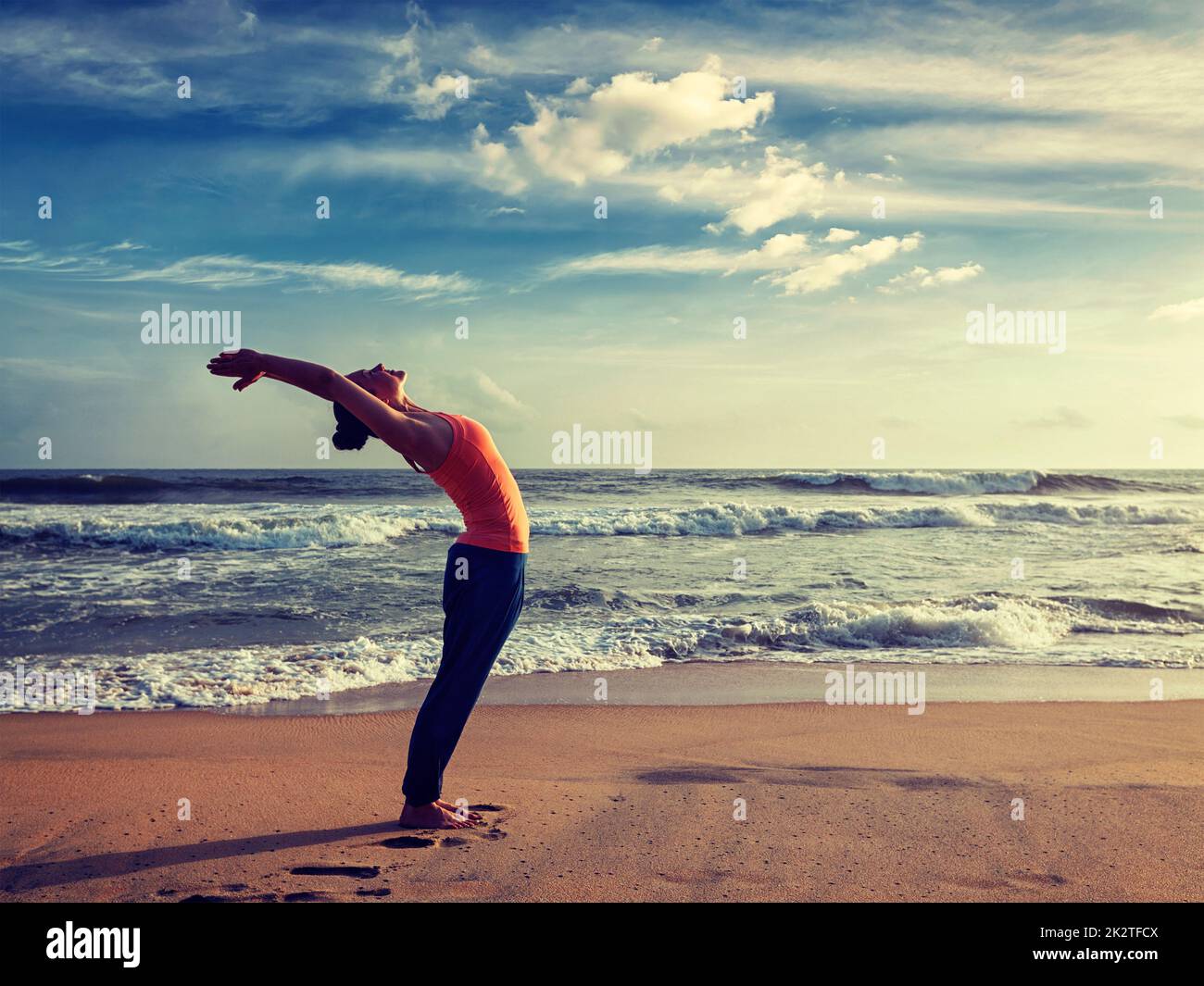 Woman beach raised arms sunset hi-res stock photography and images - Alamy