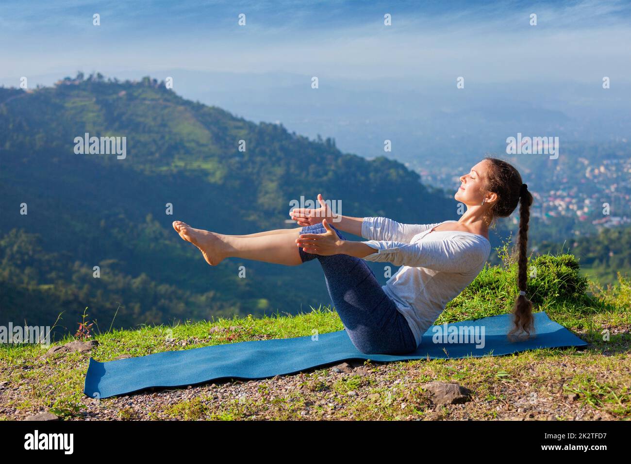Woman doing Ashtanga Vinyasa Yoga asana Navasana - boat pose Stock ...