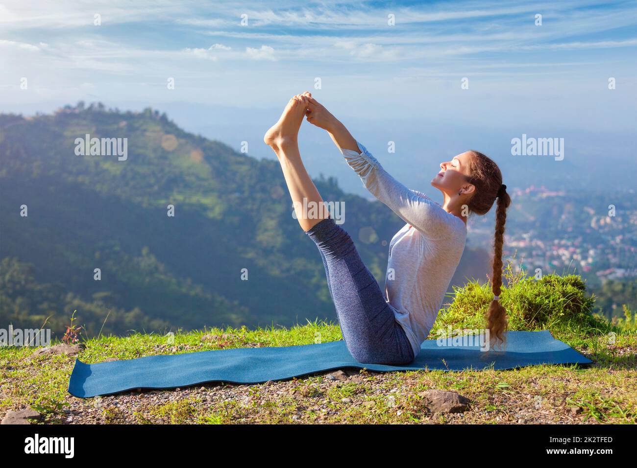 Woman doing Ashtanga Vinyasa Yoga asana outdoors Stock Photo - Alamy
