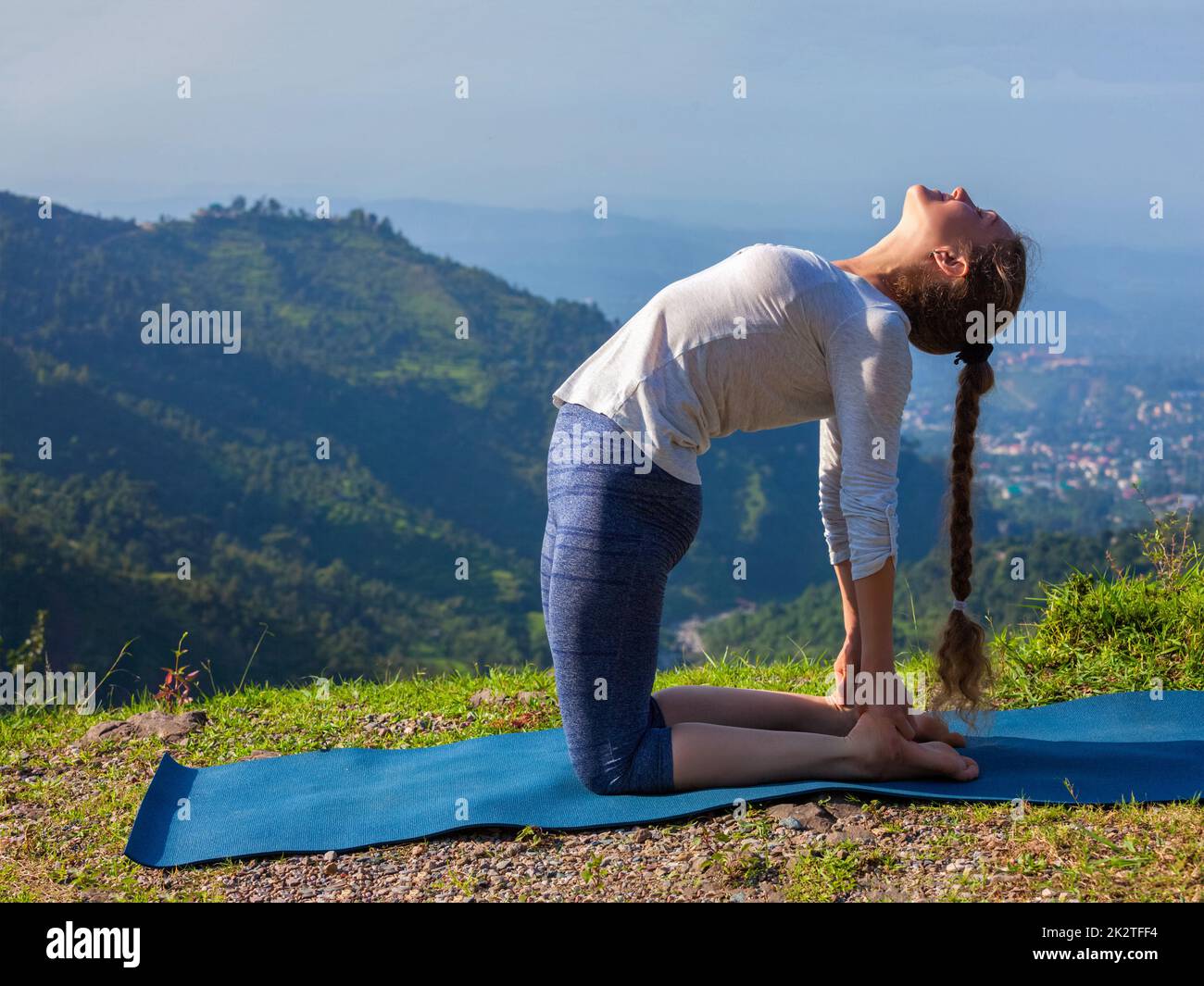 Woman doing yoga asana Ustrasana camel pose outdoors Stock Photo - Alamy