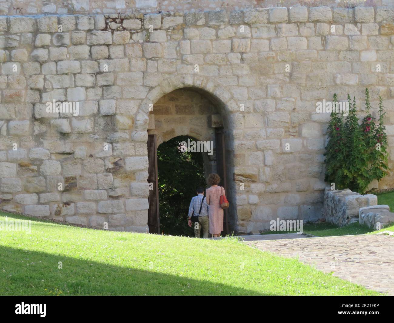 people leaving through the gate of the ancient tradition wall Stock ...