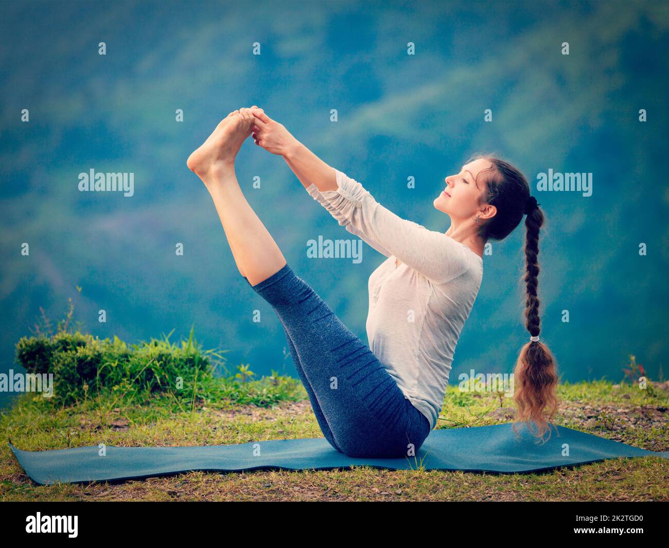 Woman doing Ashtanga Vinyasa Yoga asana outdoors Stock Photo - Alamy