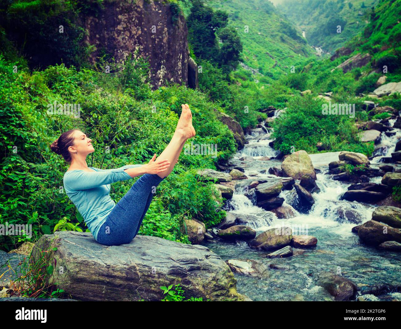 Woman doing Ashtanga Vinyasa Yoga asana Navasana - boat pose Stock ...