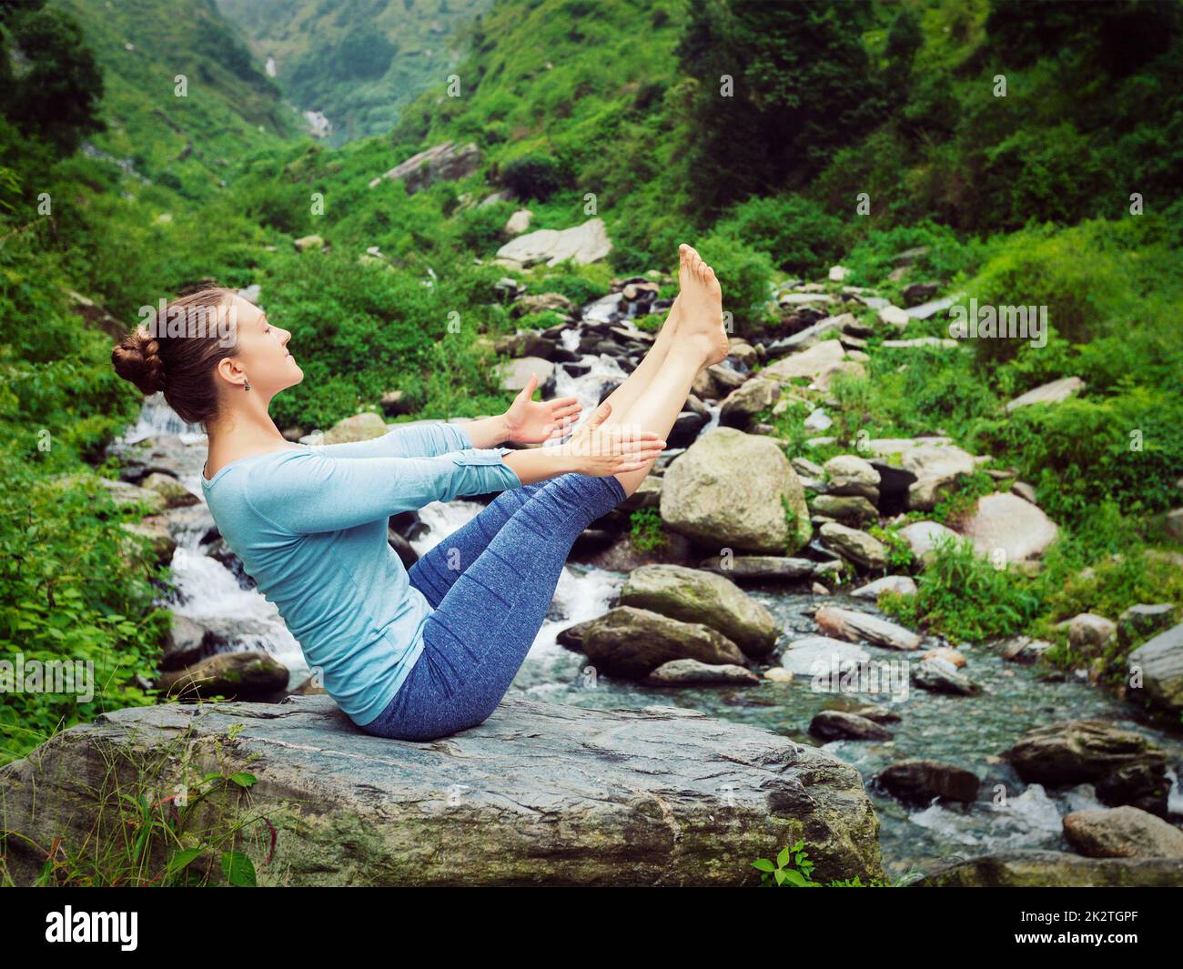Woman doing Ashtanga Vinyasa Yoga asana Navasana - boat pose Stock ...