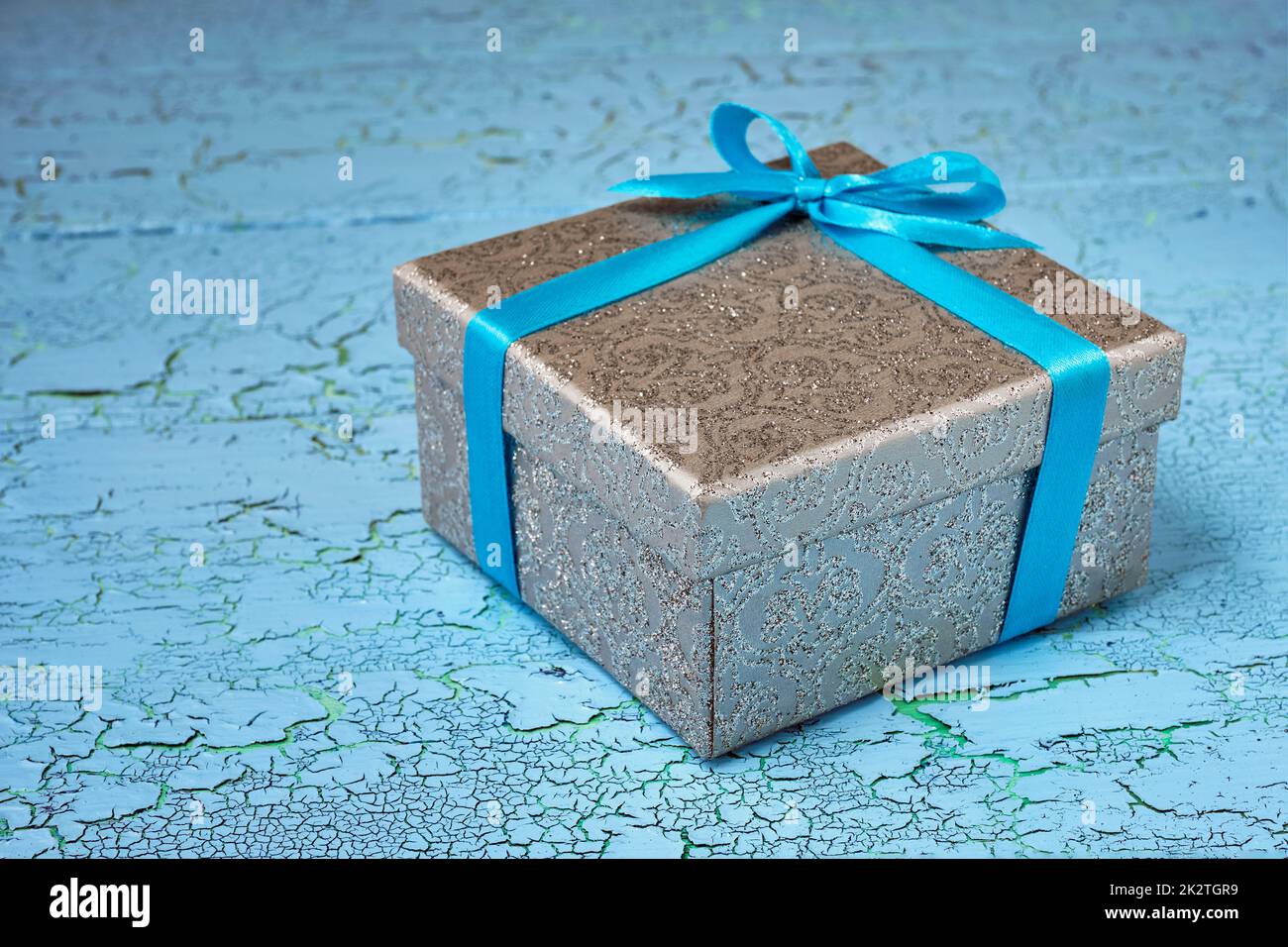 Gift box with blue ribbon Stock Photo - Alamy