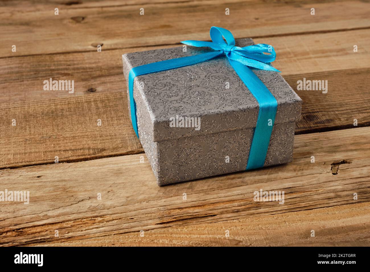Gift box with blue ribbon Stock Photo - Alamy