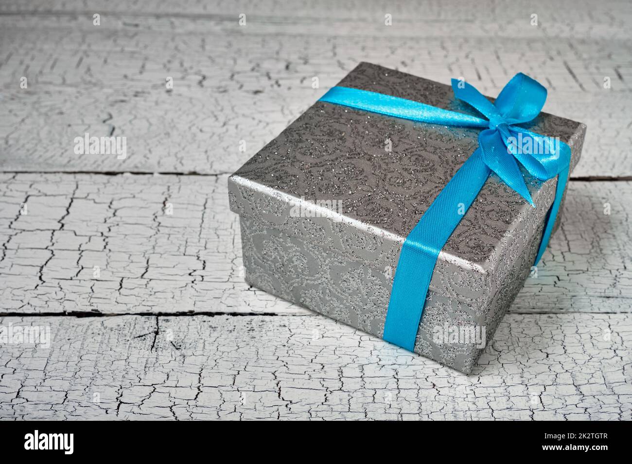 Gift box with blue ribbon Stock Photo - Alamy