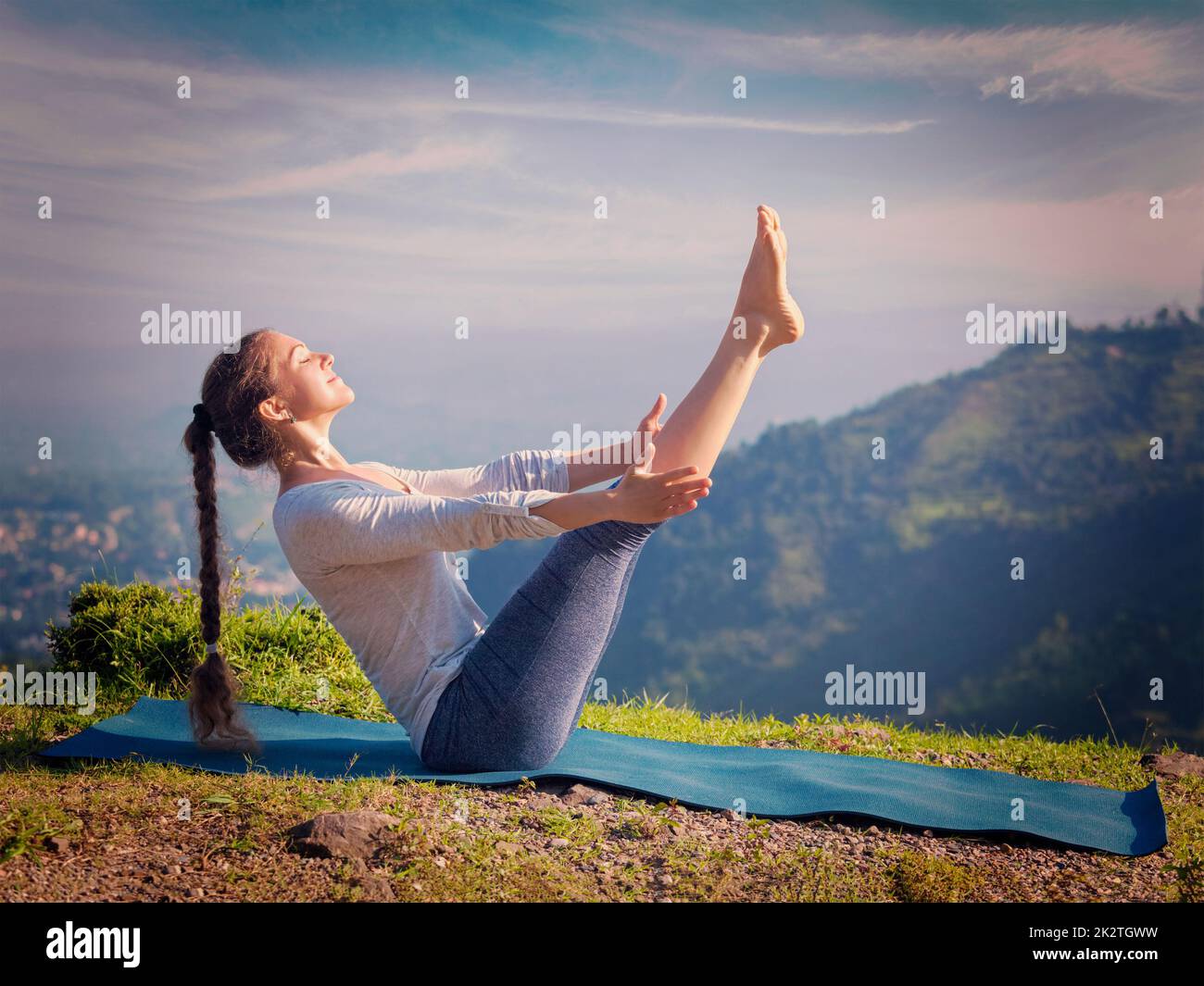 Woman doing Ashtanga Vinyasa Yoga asana Navasana - boat pose Stock ...
