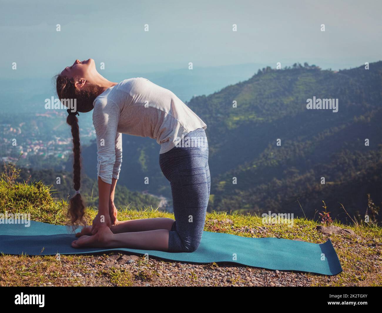 Woman doing yoga asana Ustrasana camel pose outdoors Stock Photo - Alamy