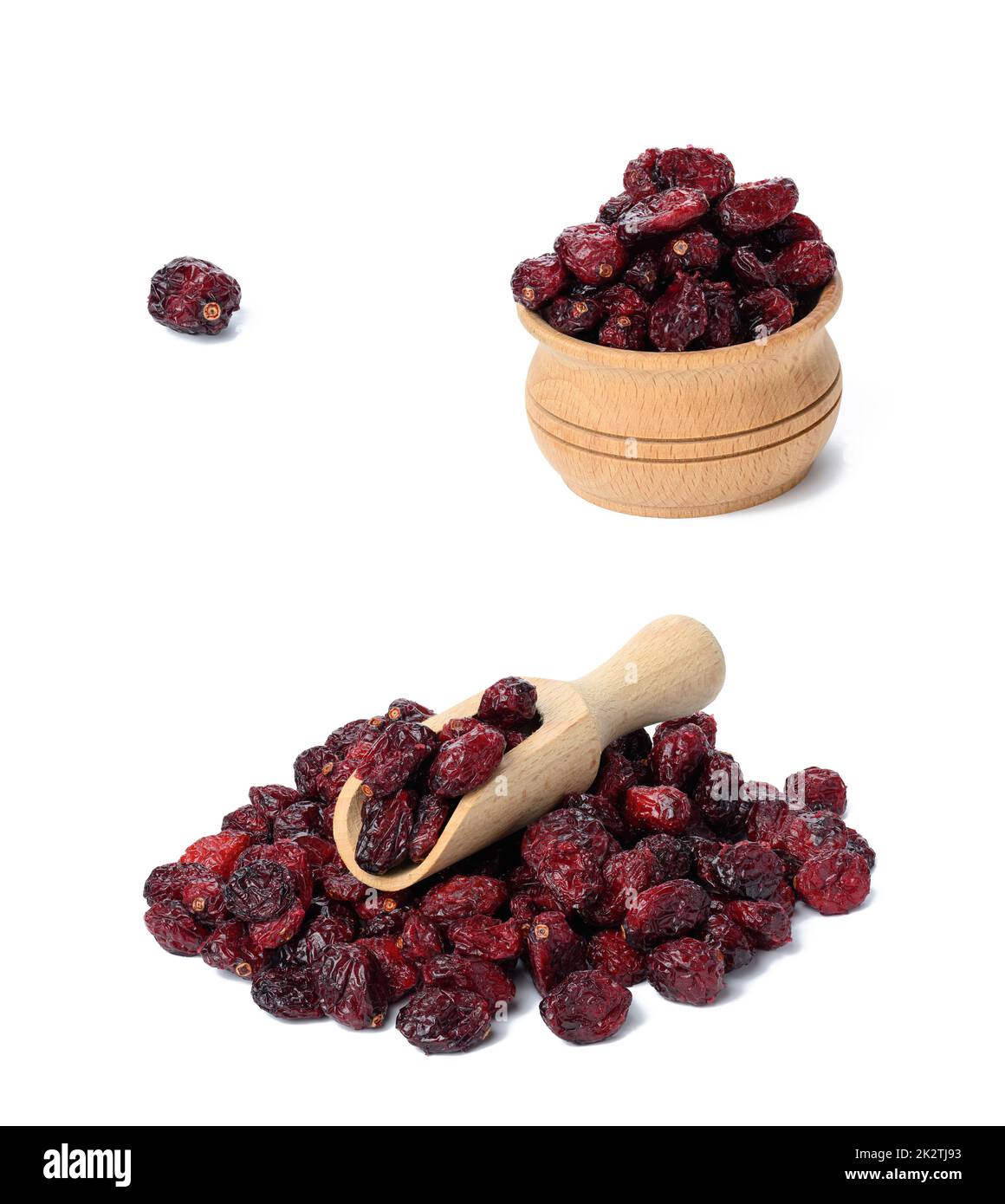 a bunch of dried cranberries in a wooden bowl on a white background ...
