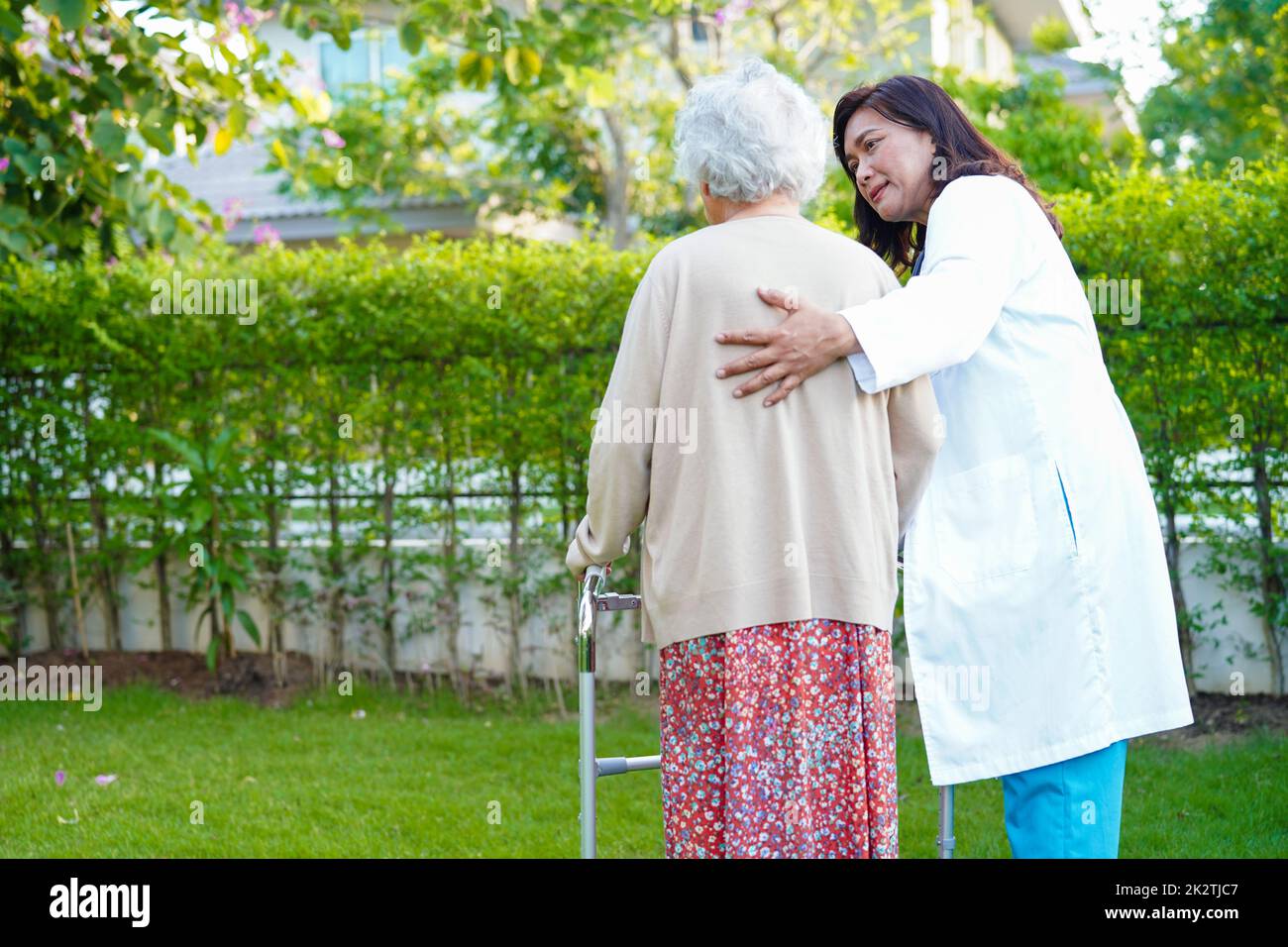 Doctor help Asian elderly woman disability patient walk with walker in ...