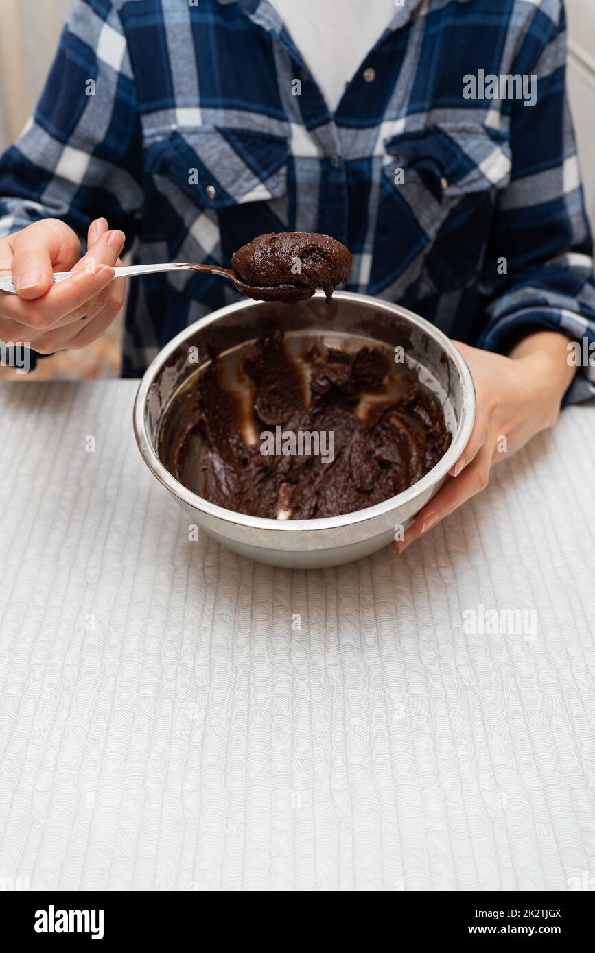 Preparation for baking chocolate brownie, dough in a metal bowl ...