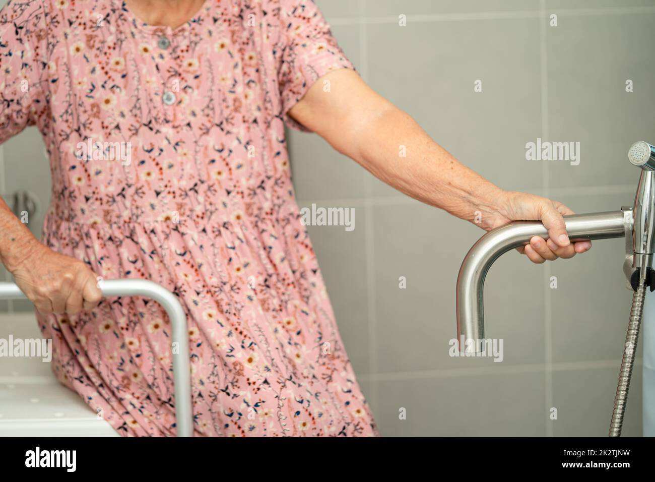 Asian senior or elderly old lady woman patient use toilet bathroom ...