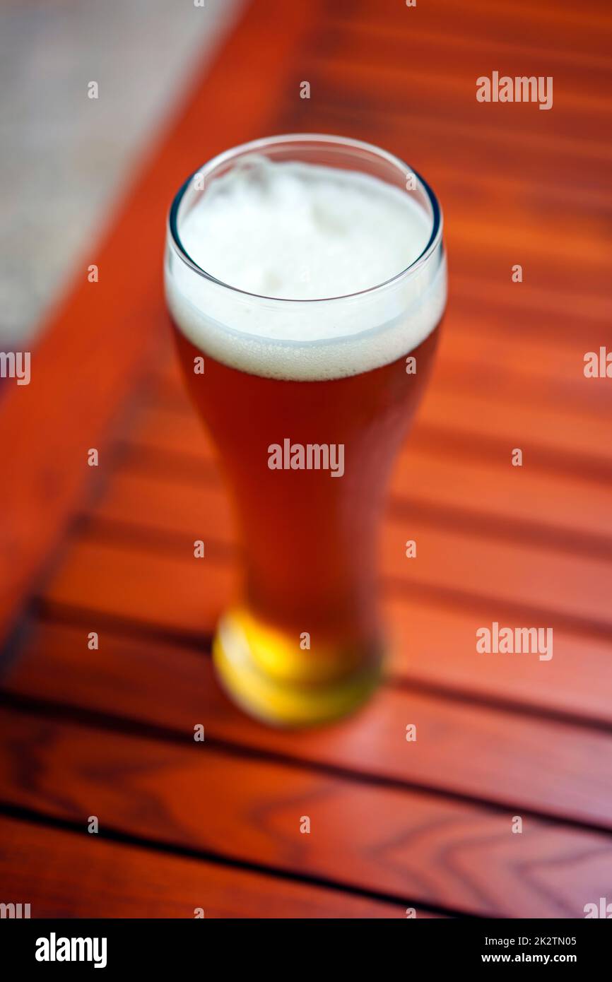 Full beer glass on a table Stock Photo - Alamy