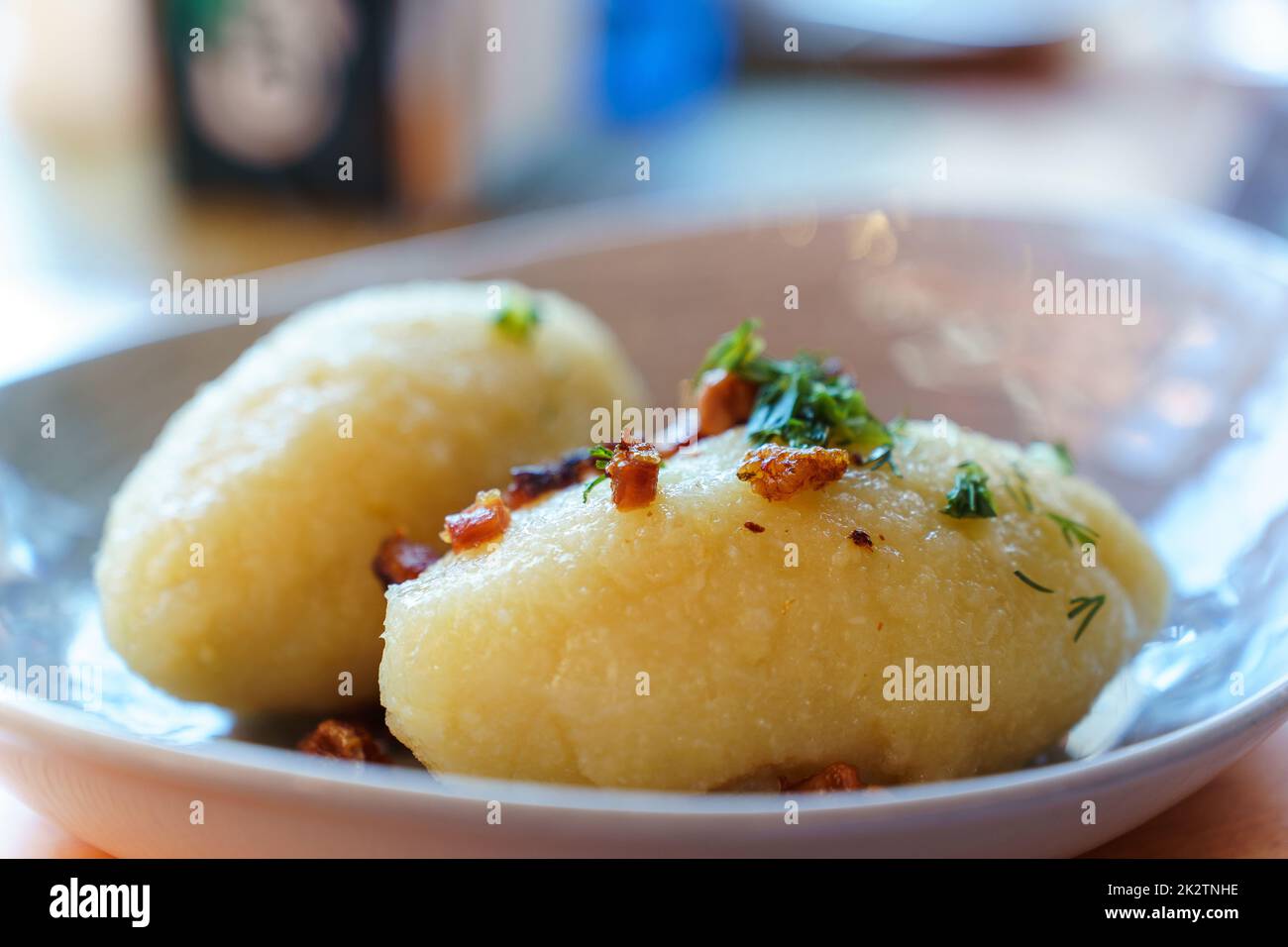National Lithuanian cuisine. Zepelins with cracklings and greens in a ...