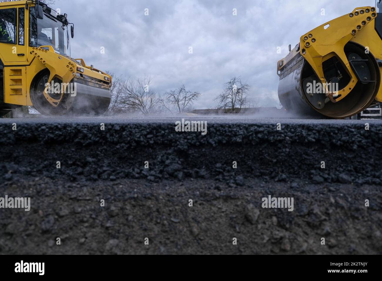Close up view of a road roller working on a new road construction site ...
