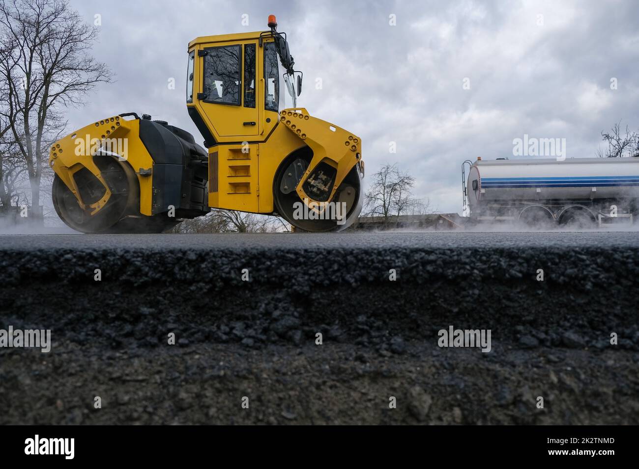Close up view of a road roller working on a new road construction site ...