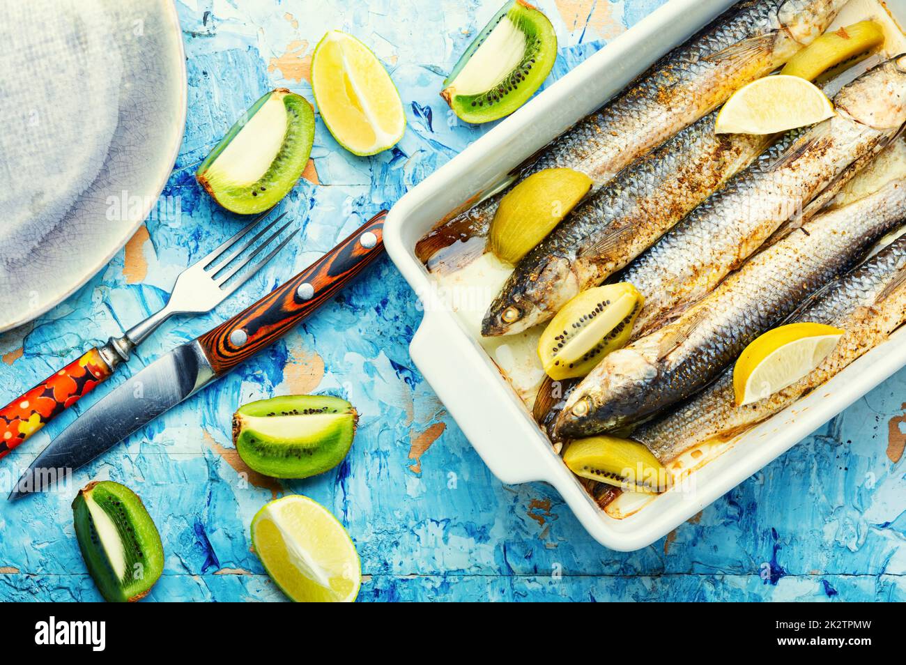 Yummy pelengas fish fried with lime and kiwi Stock Photo - Alamy