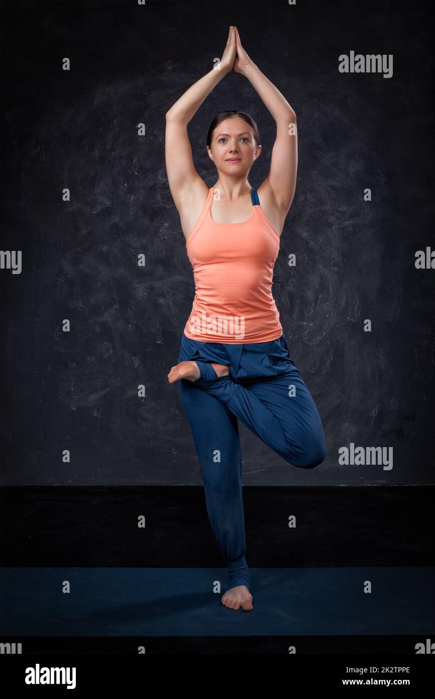 Woman practices yoga asana Vrikshasana tree po Stock Photo - Alamy
