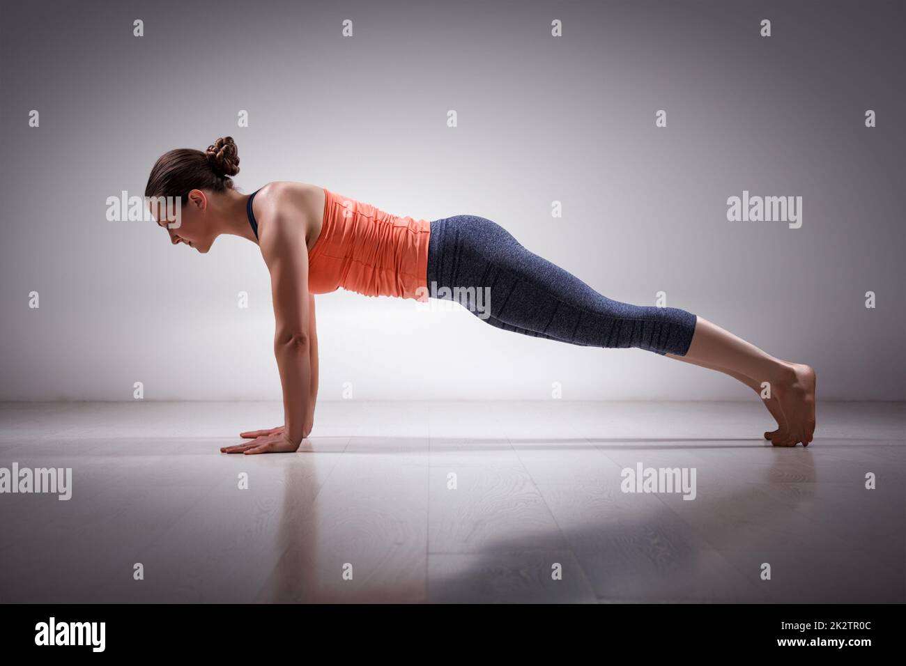 Woman does yoga asana Utthita Chaturanga Dandasa Stock Photo - Alamy