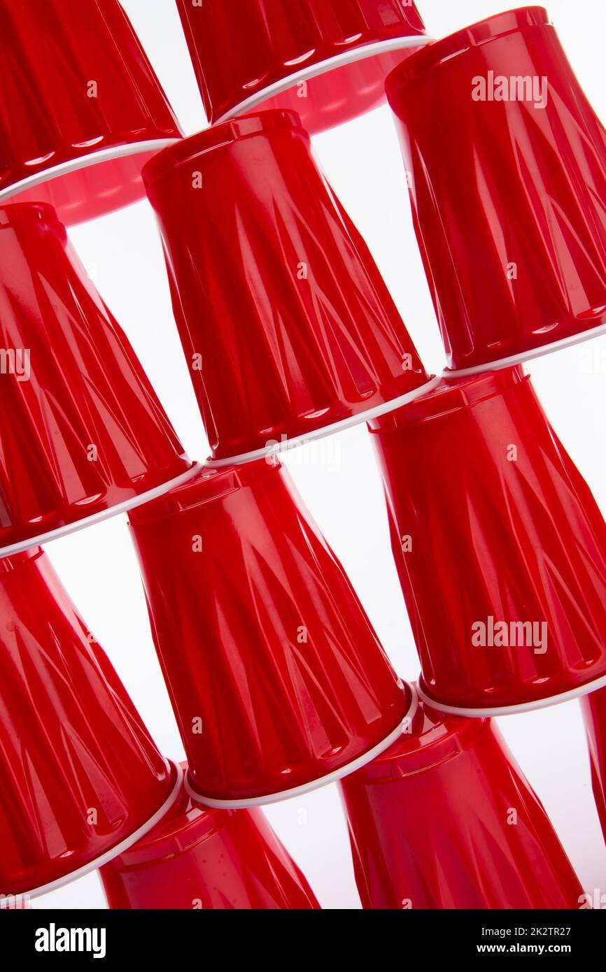 A closeup of a cup pyramid made of red disposable plastic cups against ...