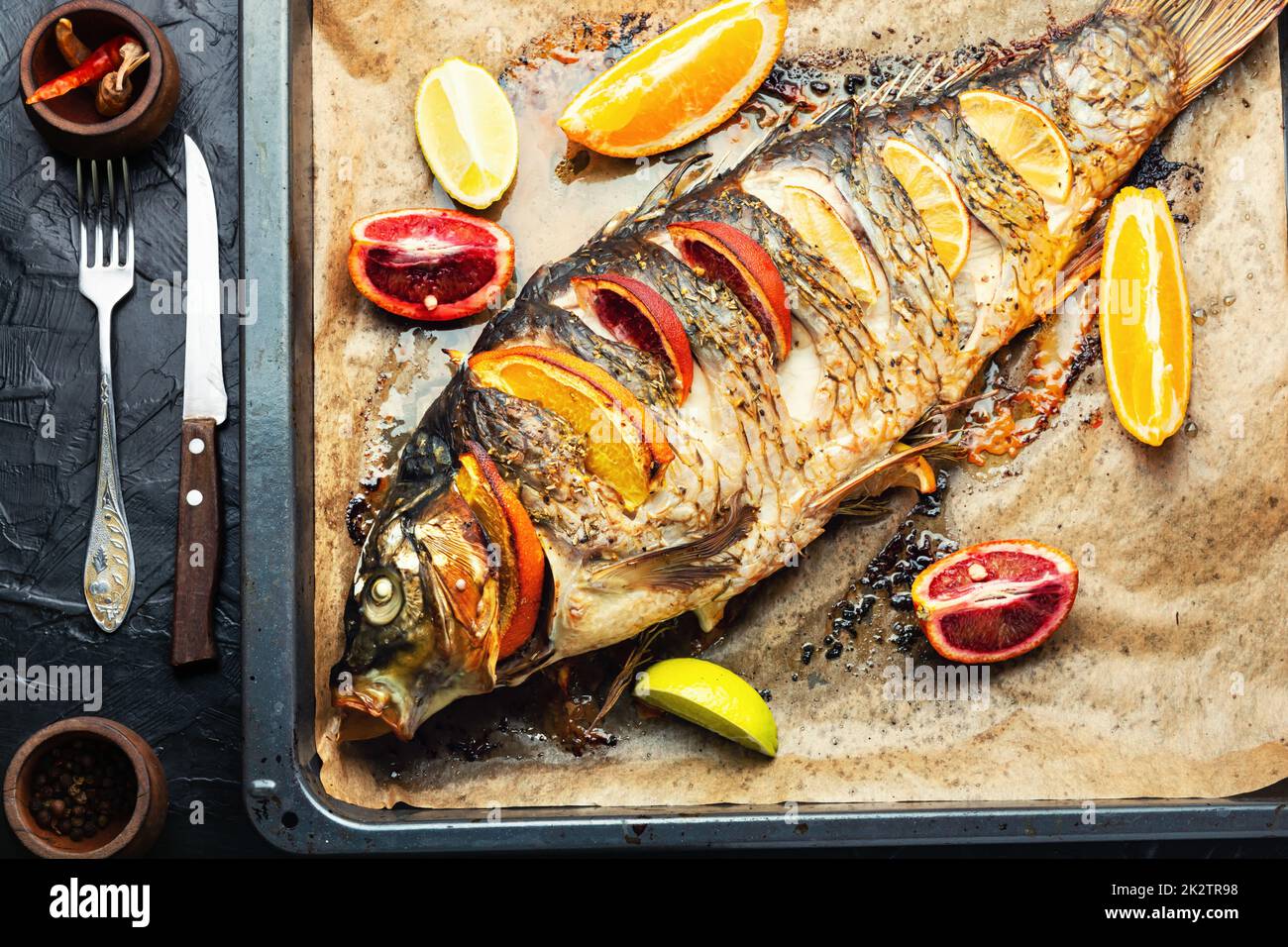 Whole baked carp with citrus fruits Stock Photo - Alamy
