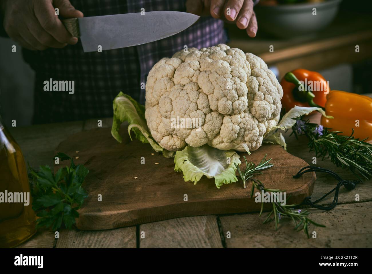 Crop man cutting ripe cauliflower Stock Photo - Alamy