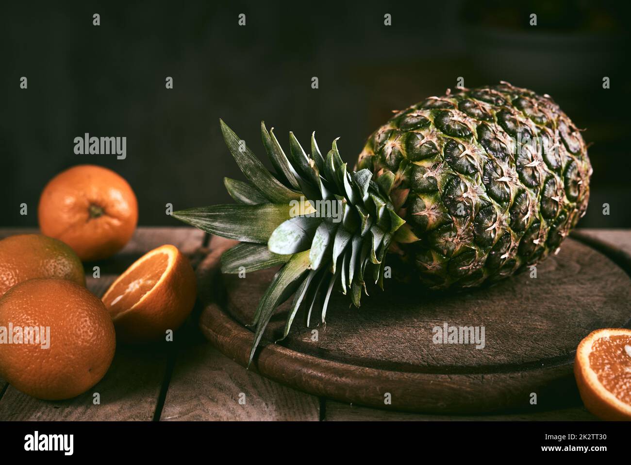 Cutting whole pineapple on board hi-res stock photography and images ...