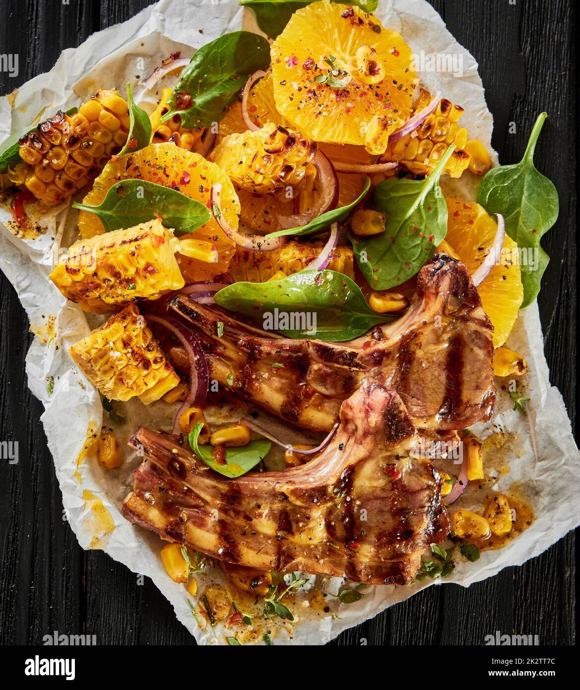 Delicious lamb chops with corn and orange slices Stock Photo - Alamy