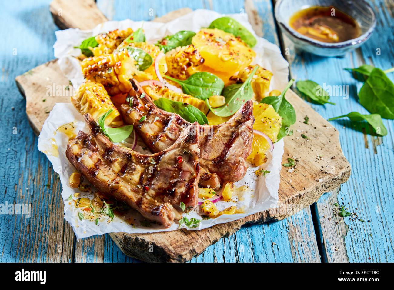 Appetizing lamb chops with corn and orange slices Stock Photo - Alamy