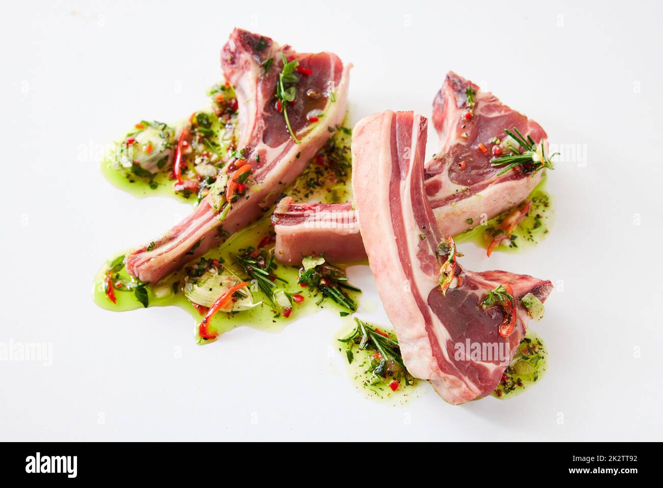 Raw lamb chops on white table Stock Photo - Alamy