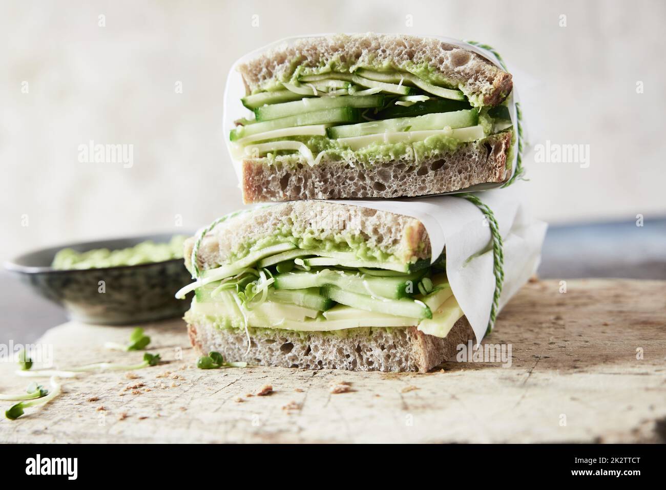 Delicious sandwiches with vegetables on table in kitchen Stock Photo ...