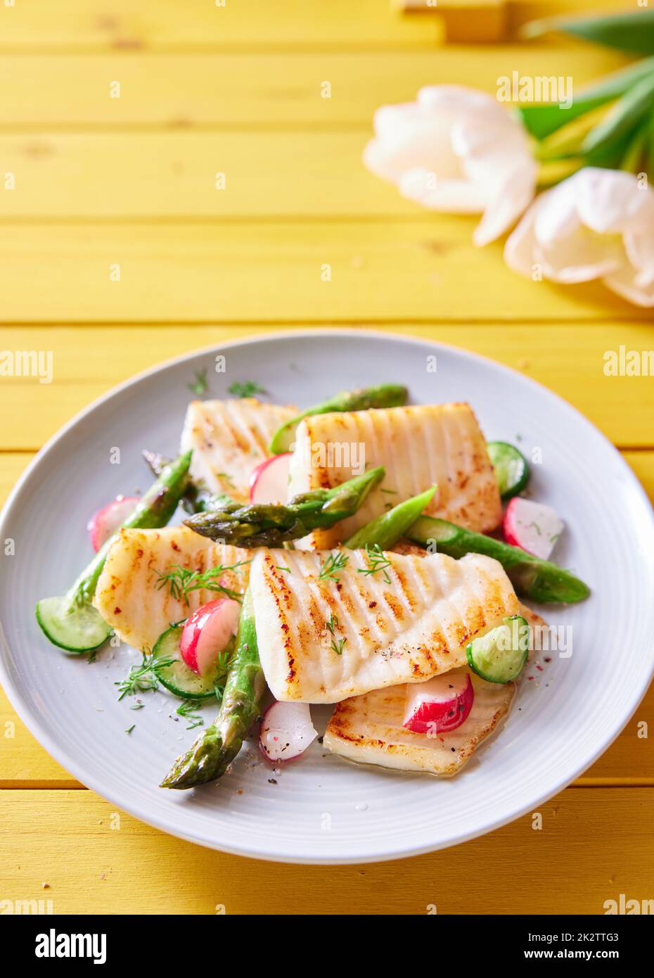 Grilled fish fillet with vegetables on plate Stock Photo - Alamy