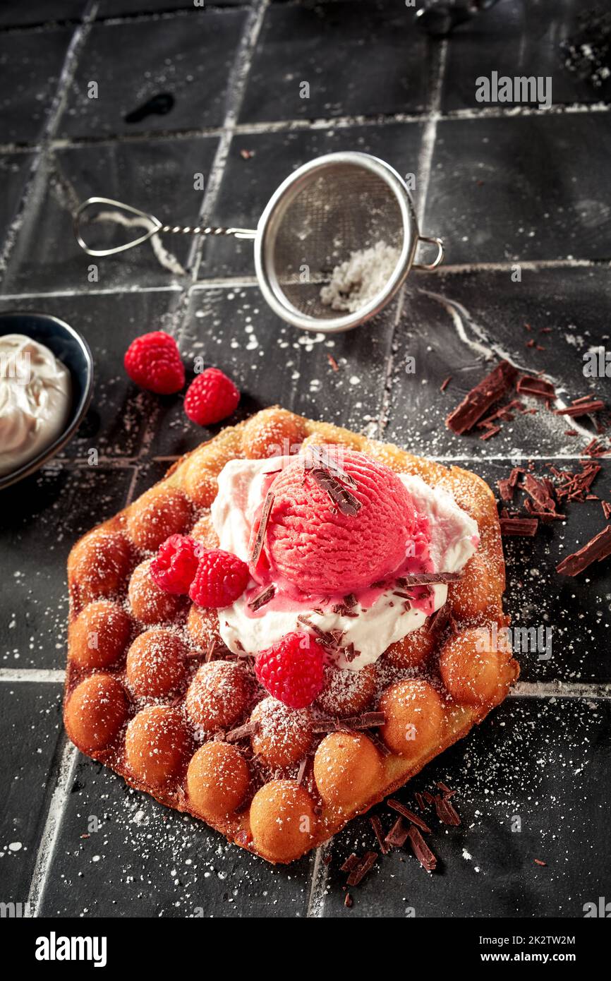 Tasty raspberry and bubble waffle summer dessert with chocolate Stock ...