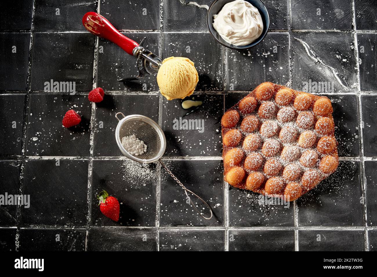 Preparing a tasty bubble waffle summer dessert with ice cream Stock ...