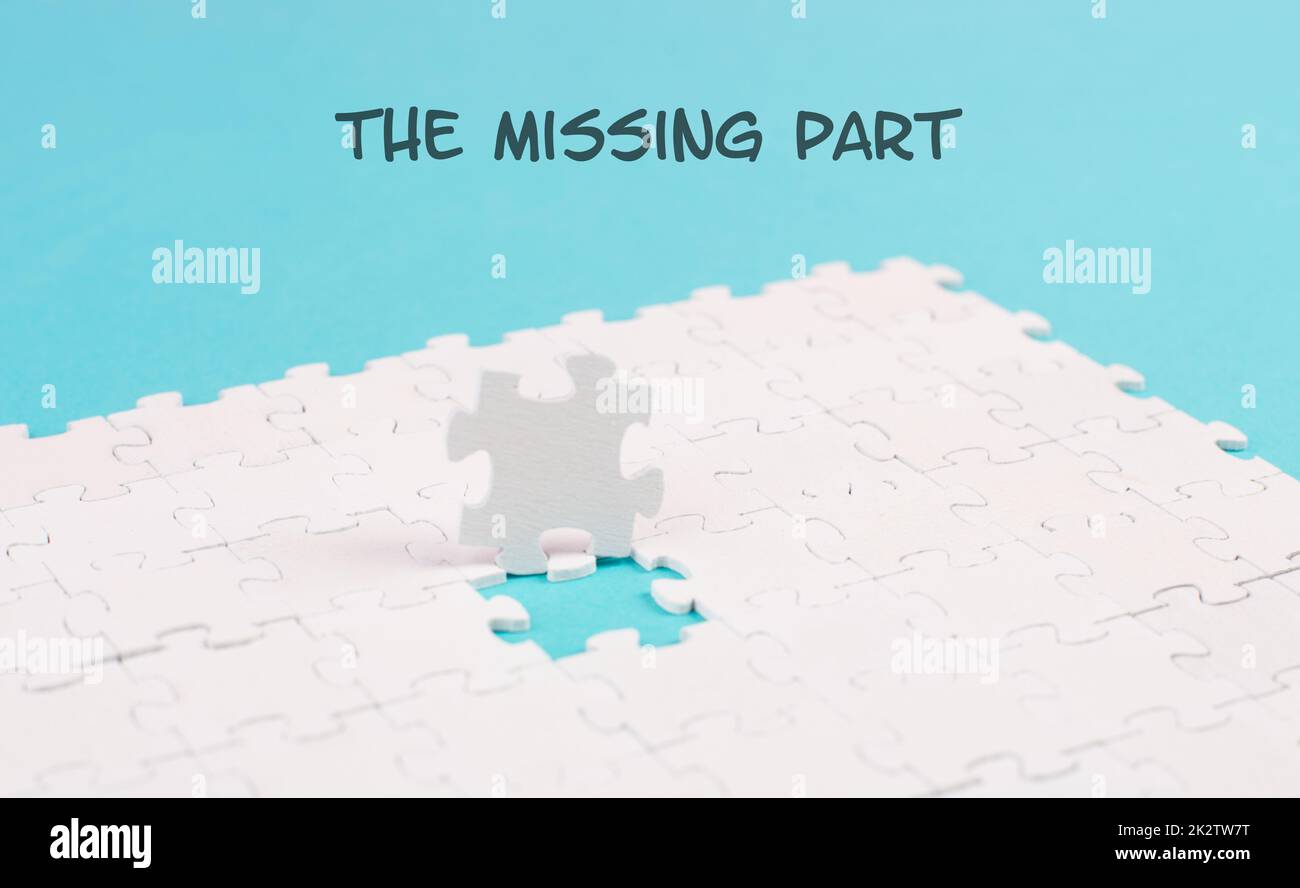 White jigsaw on a blue background, the missing part is standing on the ...