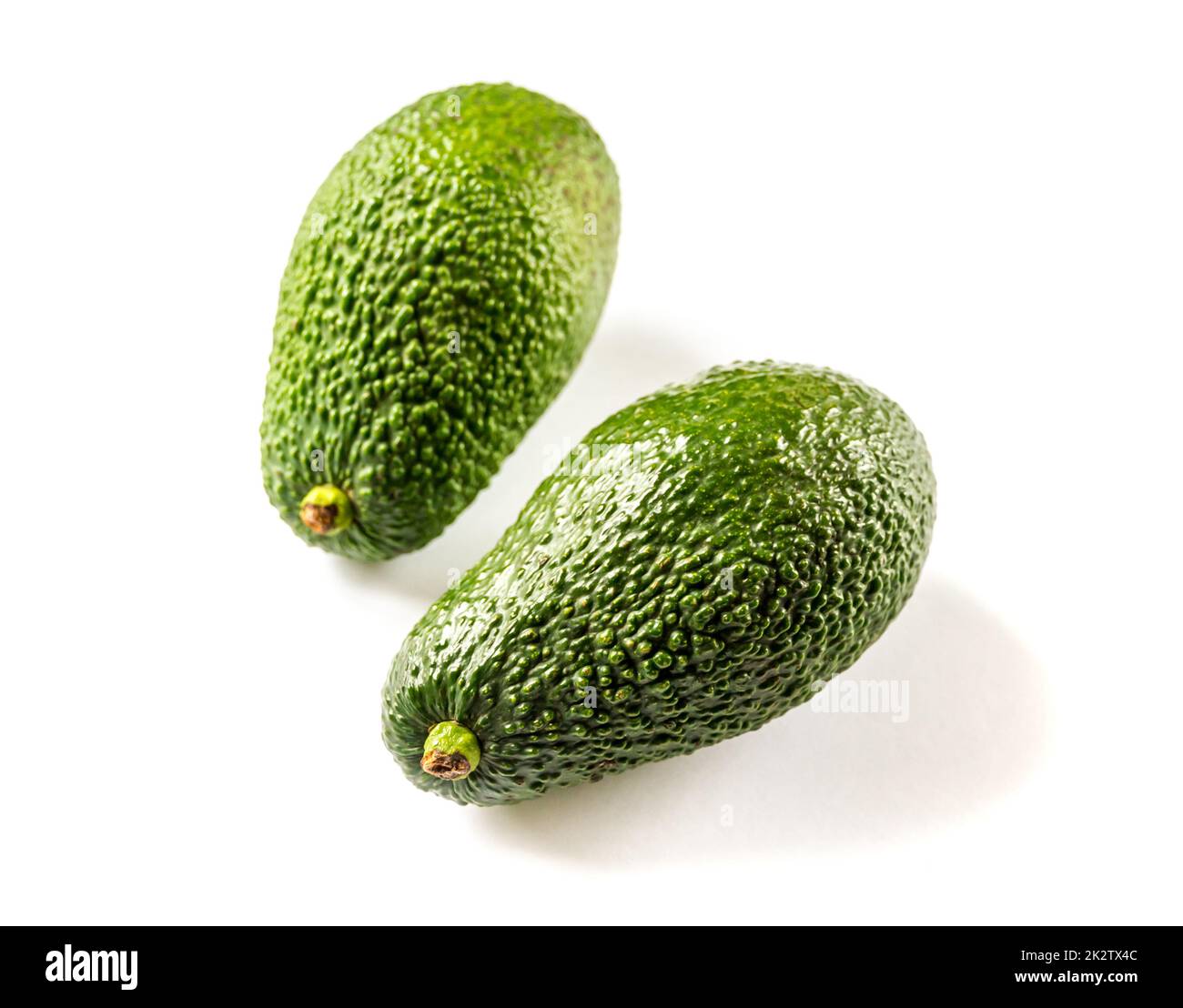 Two avocados isolated on a white background Stock Photo - Alamy