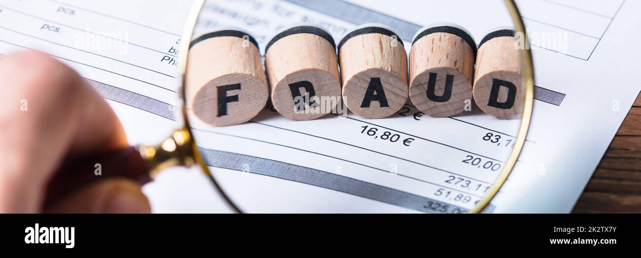 Human Hand Looking At Fraud Blocks Through Magnifying Glass Stock Photo ...